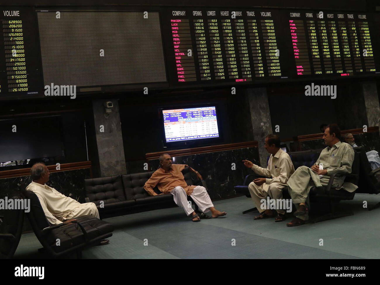 Traders monitoring shares prices during trading at Karachi Stock Exchange on Monday, January 18 ...