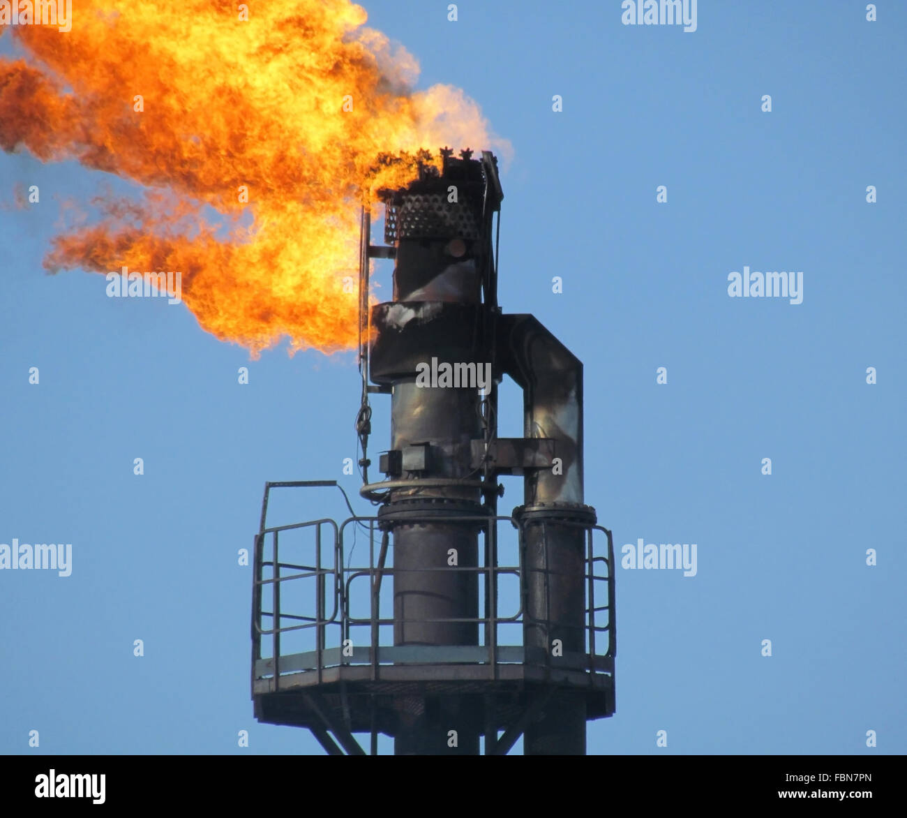 System of a torch on an oil field. Burning through a torch head Stock ...