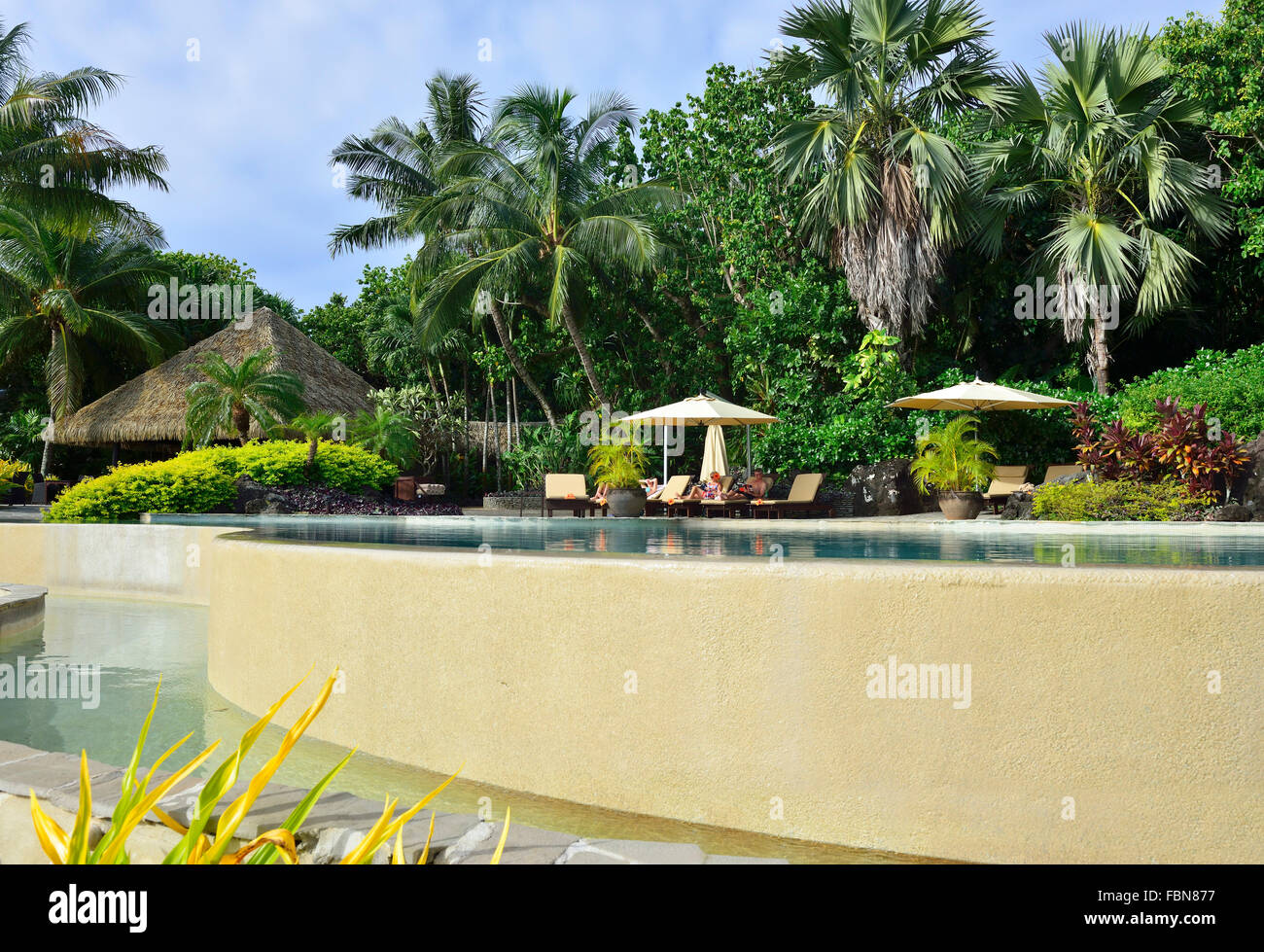 Guests relaxing by the infinity pool at Pacific Resort on the small ...