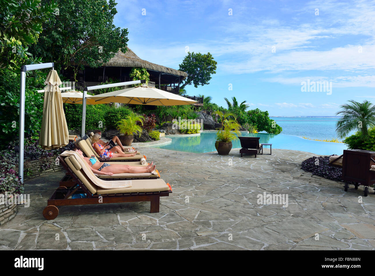 Guests relaxing by the infinity pool at Pacific Resort on the small ...