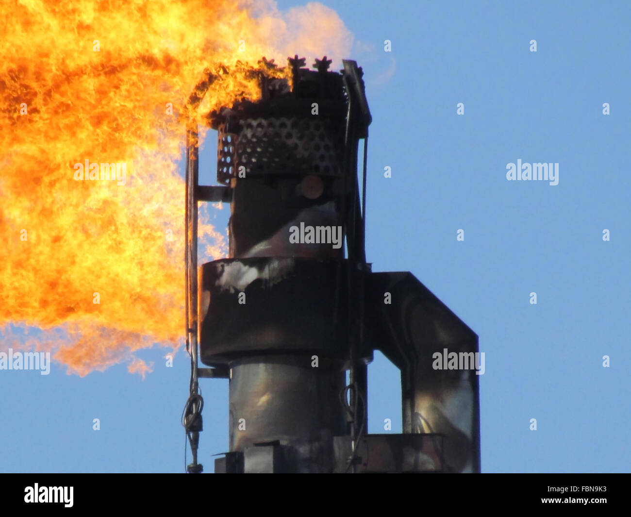 System of a torch on an oil field. Burning through a torch head Stock ...