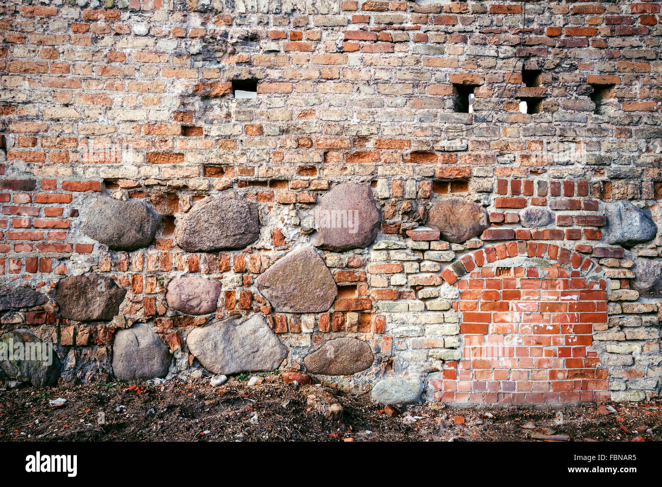 Wall of mixed materials - stone and bricks Stock Photo - Alamy