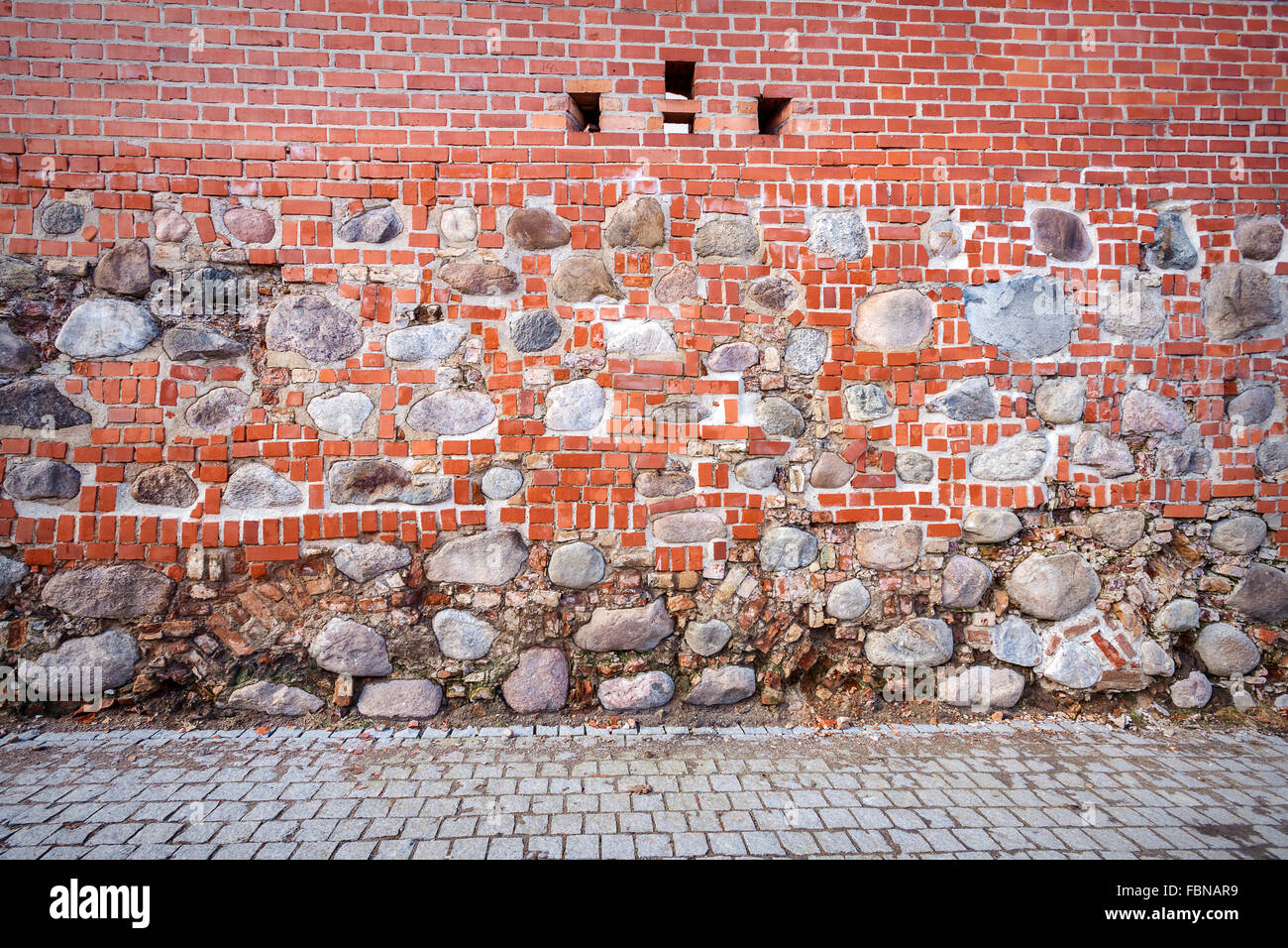 Wall of mixed materials - stone and bricks Stock Photo - Alamy