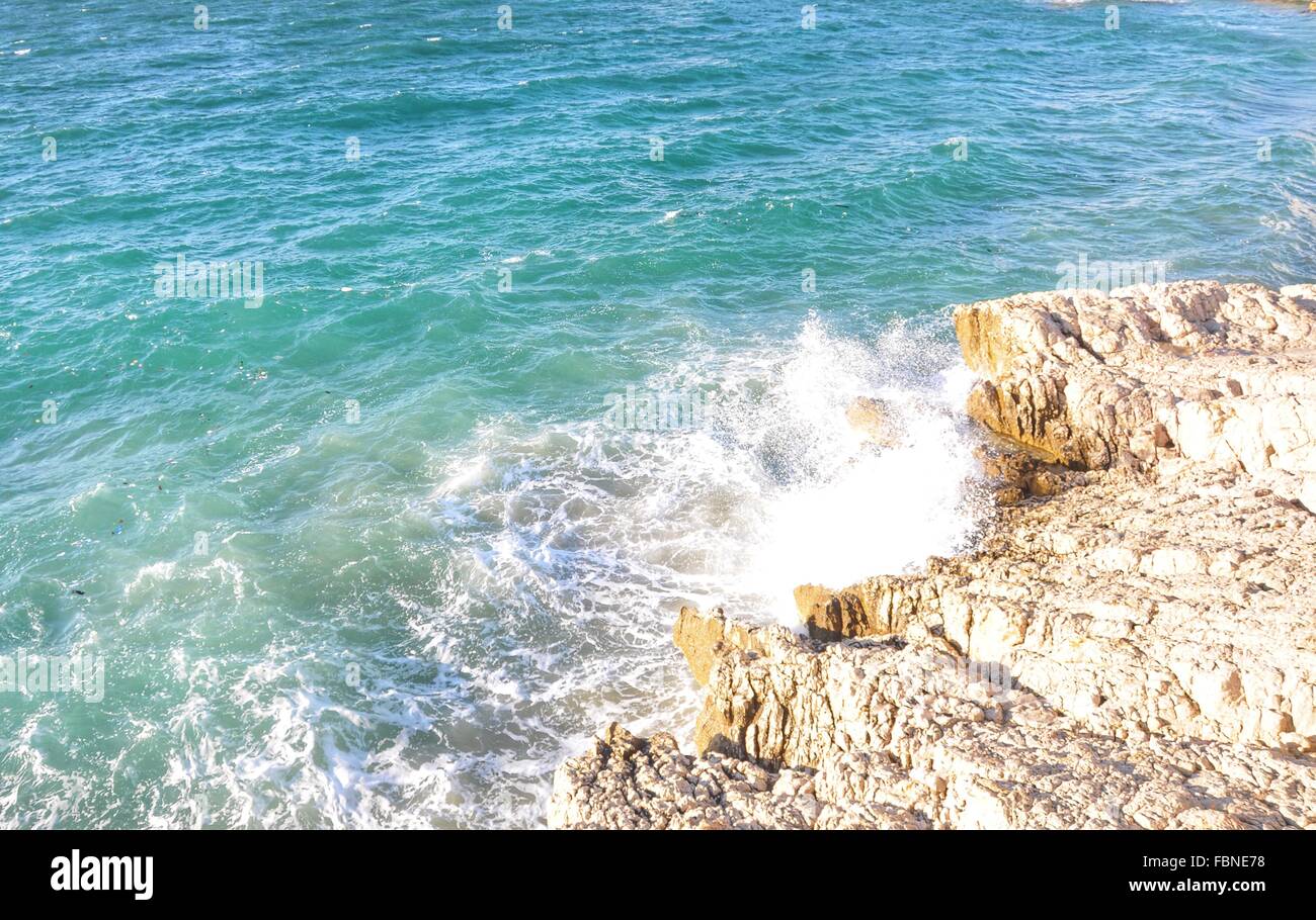 Wave Splashing On Rock Stock Photo - Alamy
