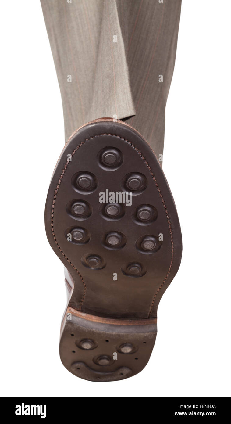 front view of male left foot in brown shoe takes a step isolated on ...