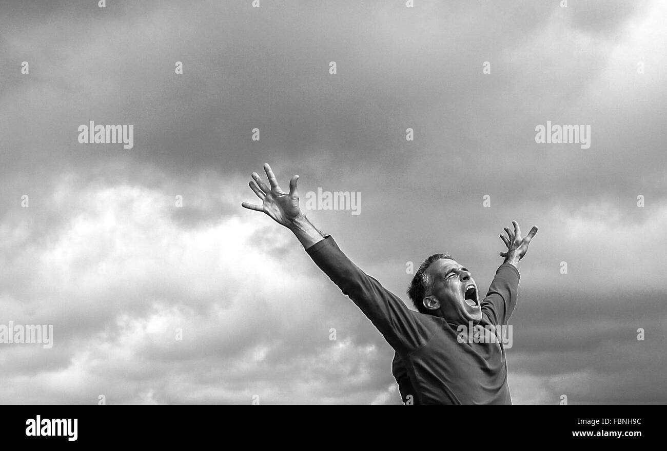 Man Shouting With Arms Raised Stock Photo - Alamy