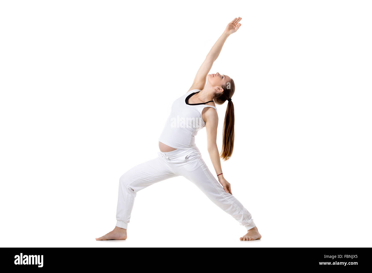 Portrait of young pregnant fitness model in white sportswear doing yoga ...