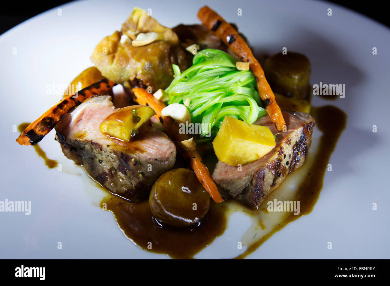 Veal served with season vegetables and jus. The meal is served in the ...