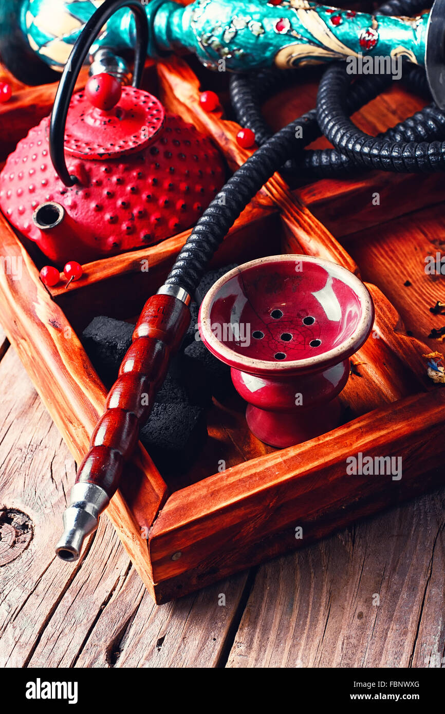 Details of smoking hookah,cast iron red teapot in wooden box Stock ...