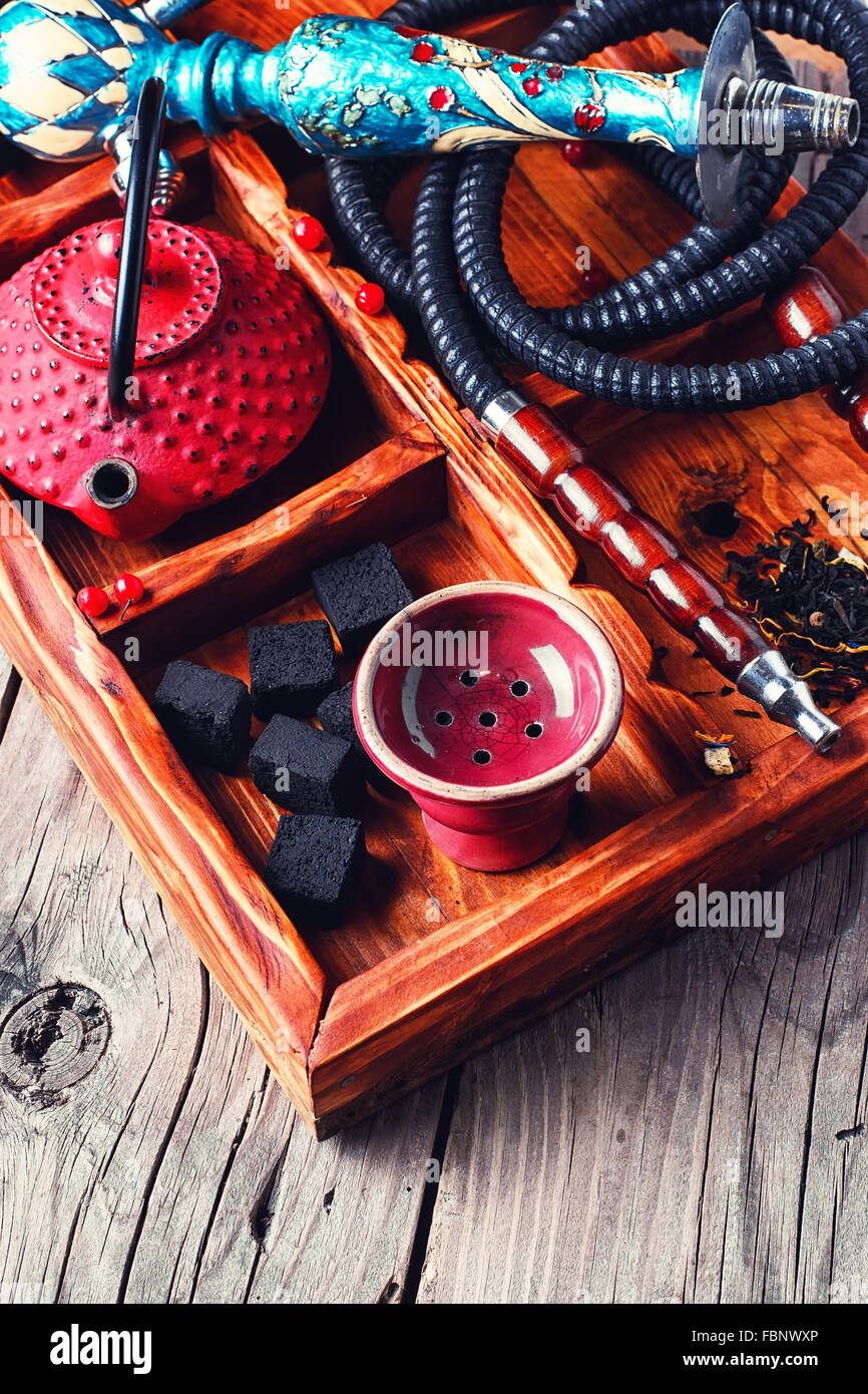 Details of smoking hookah,cast iron red teapot in wooden box Stock ...