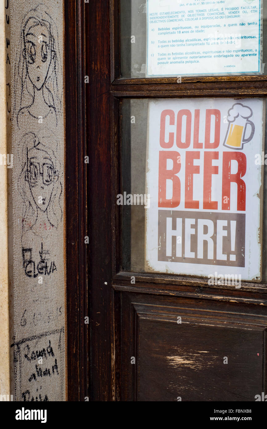 door of a bar with a 'cold beer here' sign in the window Stock Photo ...