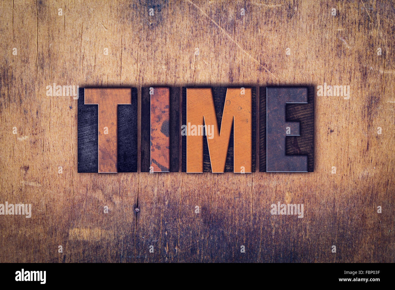 The word "Time" written in dirty vintage letterpress type on a aged ...