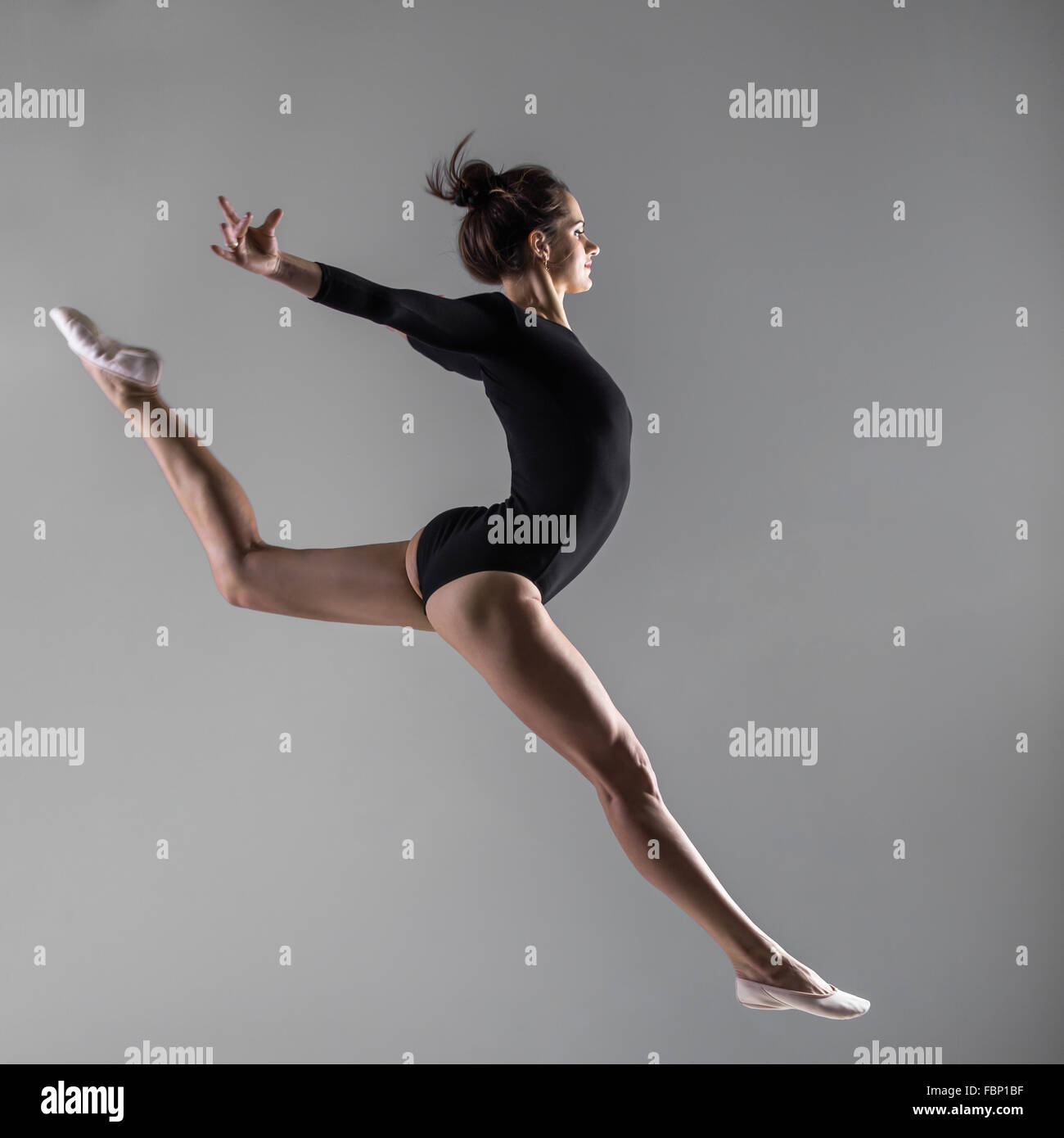 Girl wearing sport body and pointe shoes is jumping in dance Stock ...