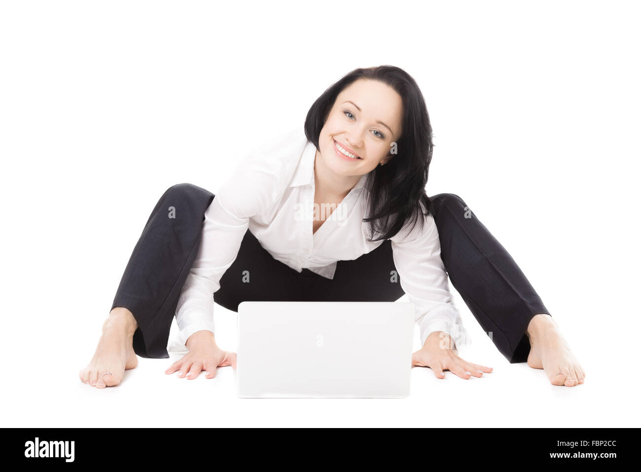 Young office woman with laptop exercising on white background Stock ...