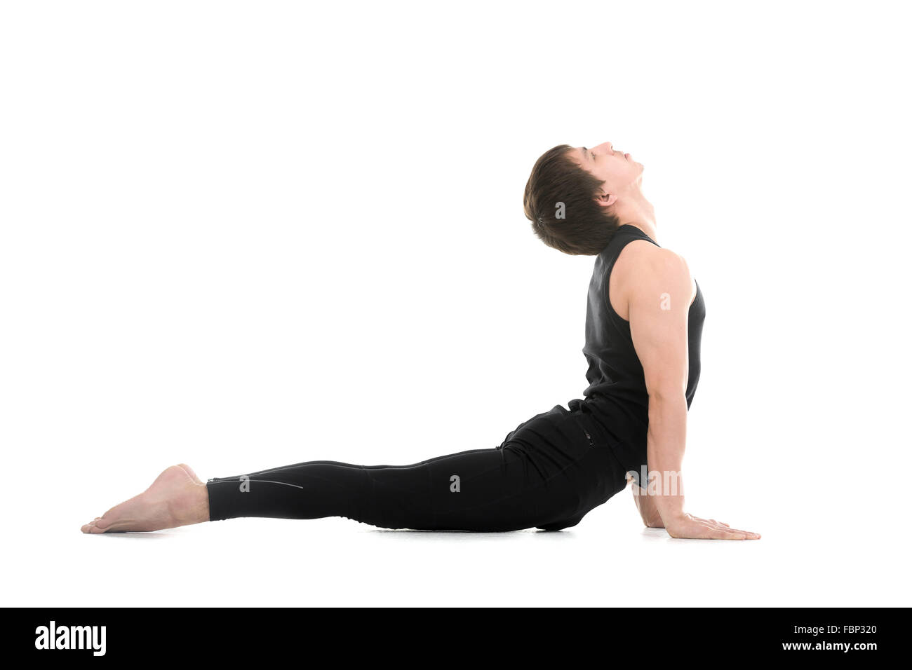 Profile of sporty young man working out, doing exercises for flexible ...