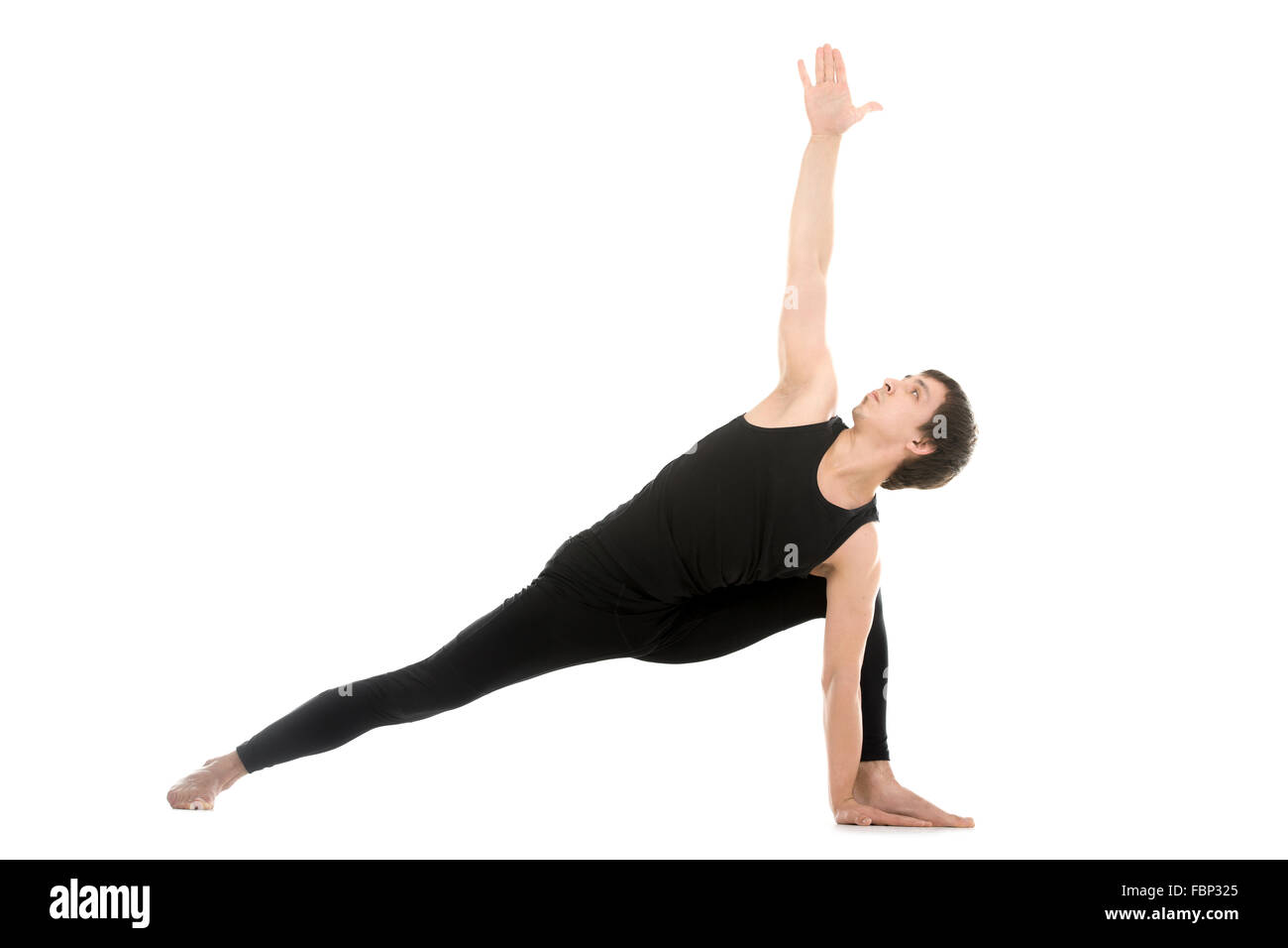 Sporty young man practicing yoga, doing stretching exercise, Extended ...