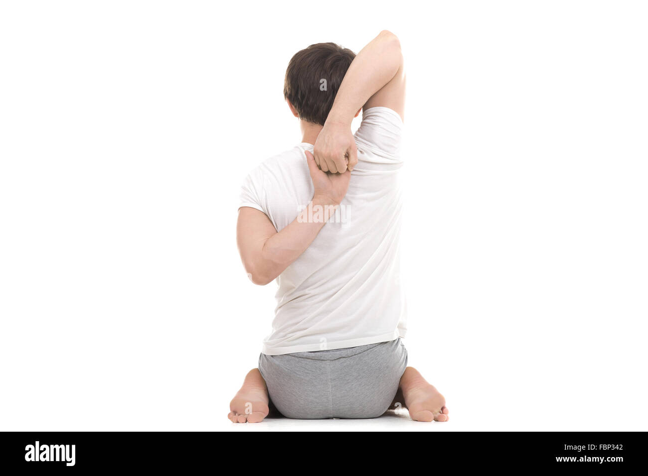 Sporty young man working out, yoga, pilates, fitness training, yoga ...