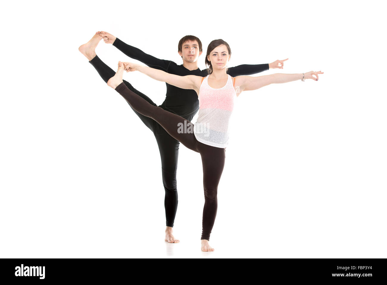 Two sporty people practice yoga with partner, couple doing stretching ...