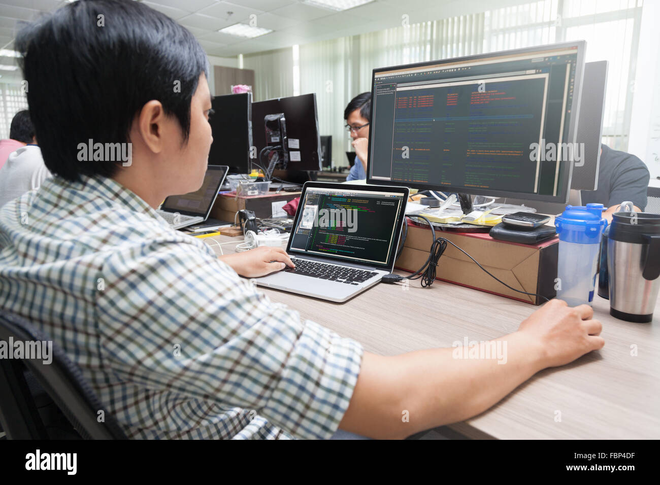 Asian Developer Using Laptop Computer Sitting Working Stock Photo - Alamy