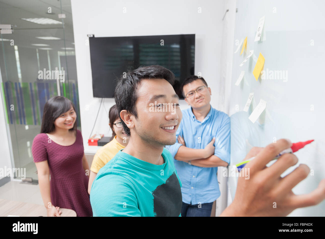 Work group brainstorming on whiteboard hi-res stock photography and ...