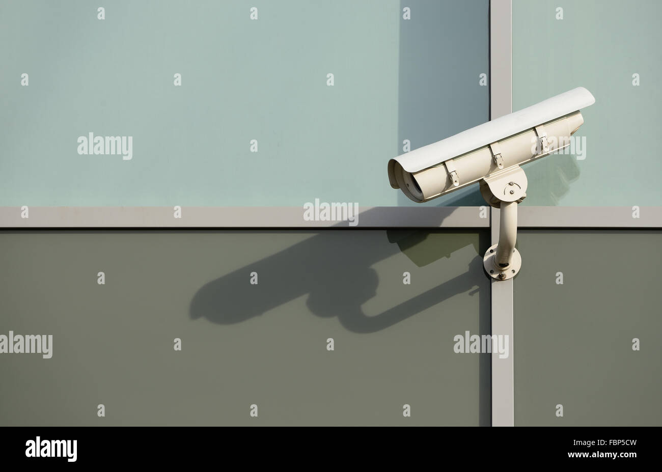 White generic security camera on modern building Stock Photo - Alamy