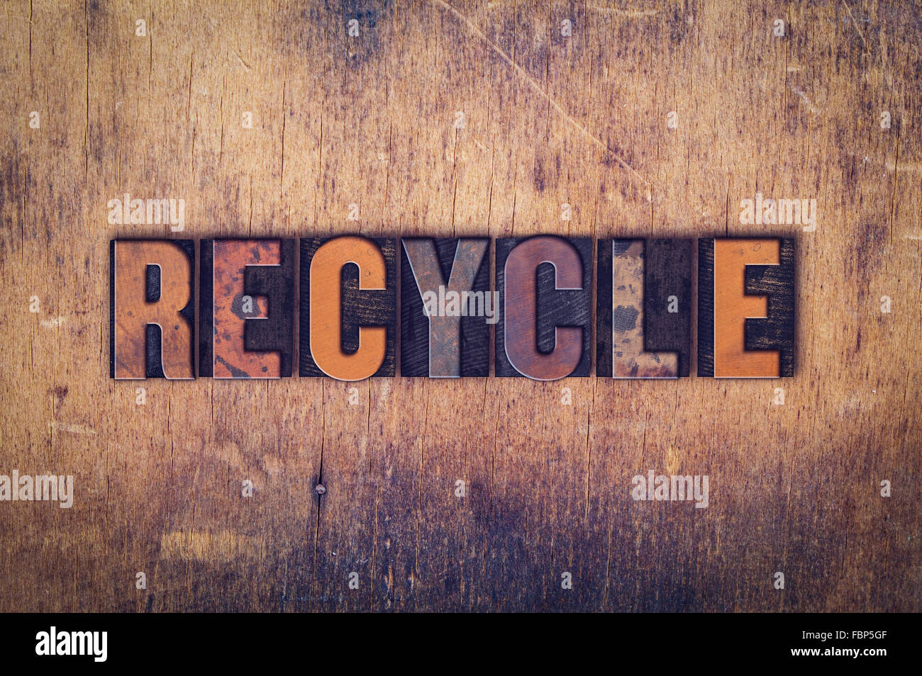 The word "Recycle" written in dirty vintage letterpress type on a aged ...