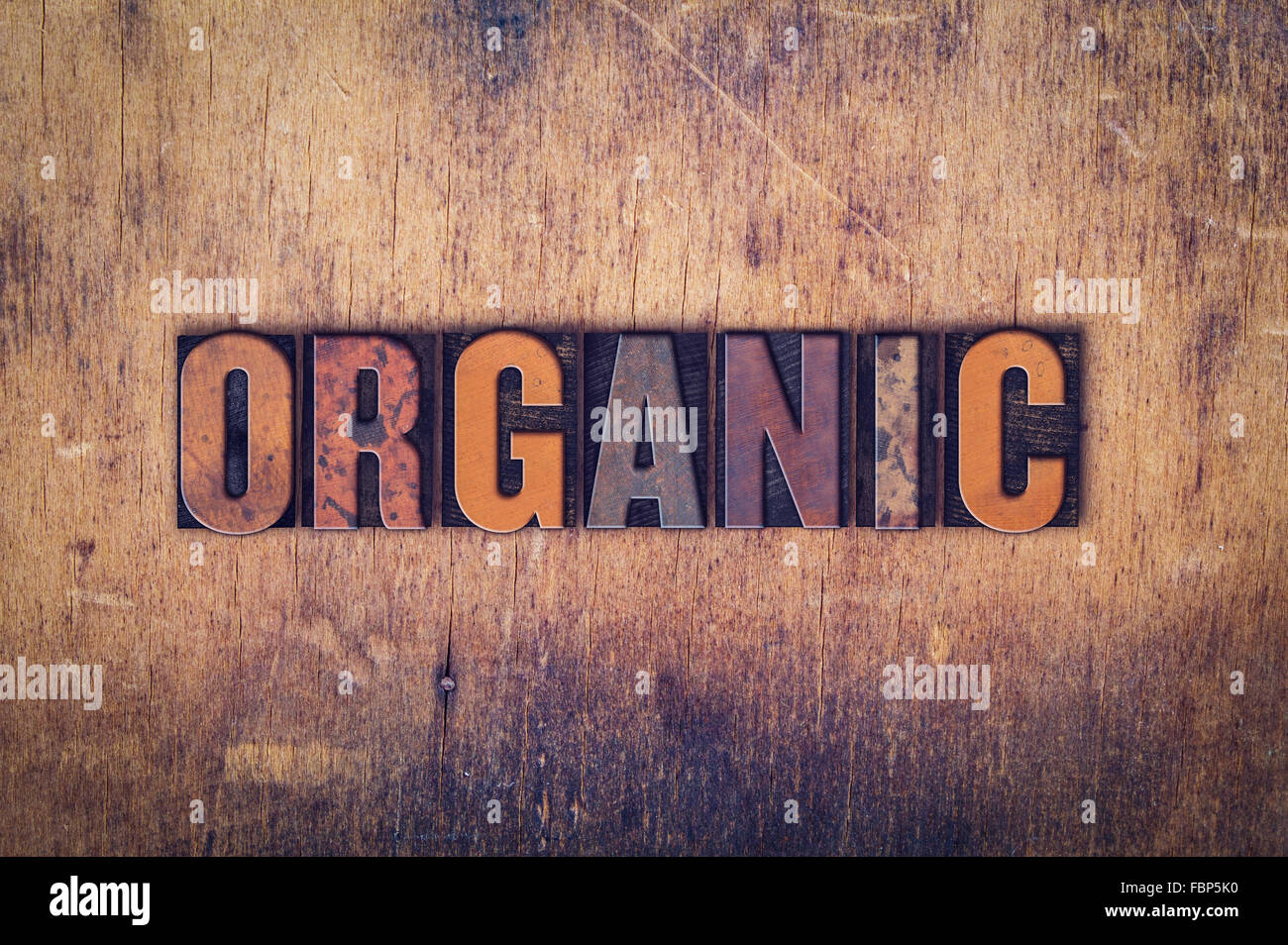 The word "Organic" written in dirty vintage letterpress type on a aged ...