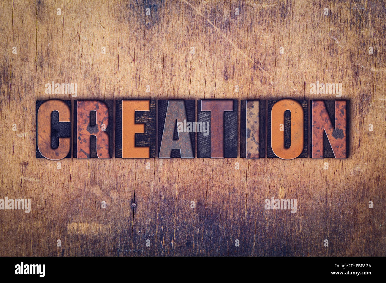 The word "Creation" written in dirty vintage letterpress type on a aged ...