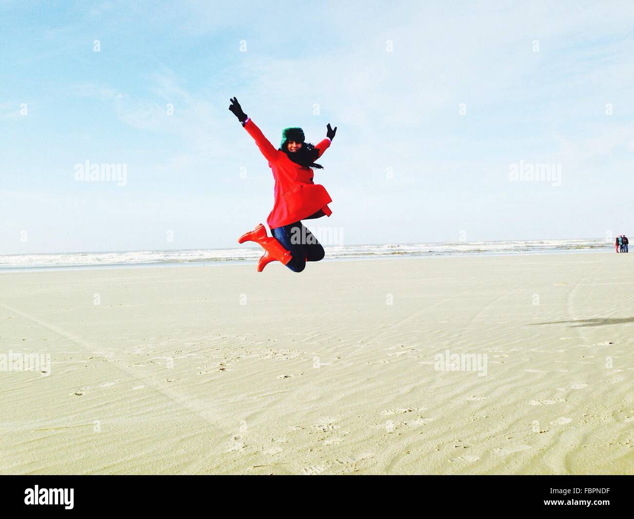 Portrait of woman jumping at beach hi-res stock photography and images ...