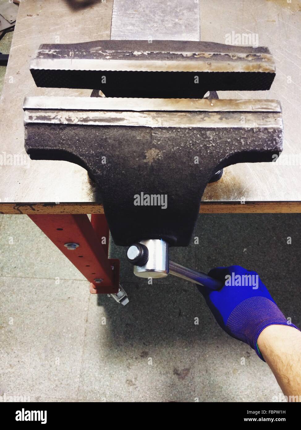 High Angle View Of Man Adjusting Clamp On Workbench Stock Photo - Alamy