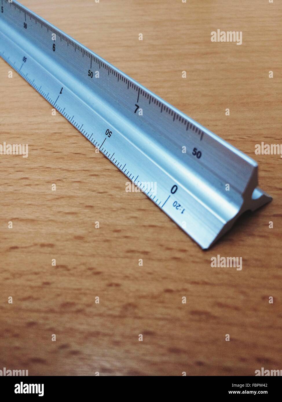 Metallic Ruler On Wooden Table Stock Photo - Alamy