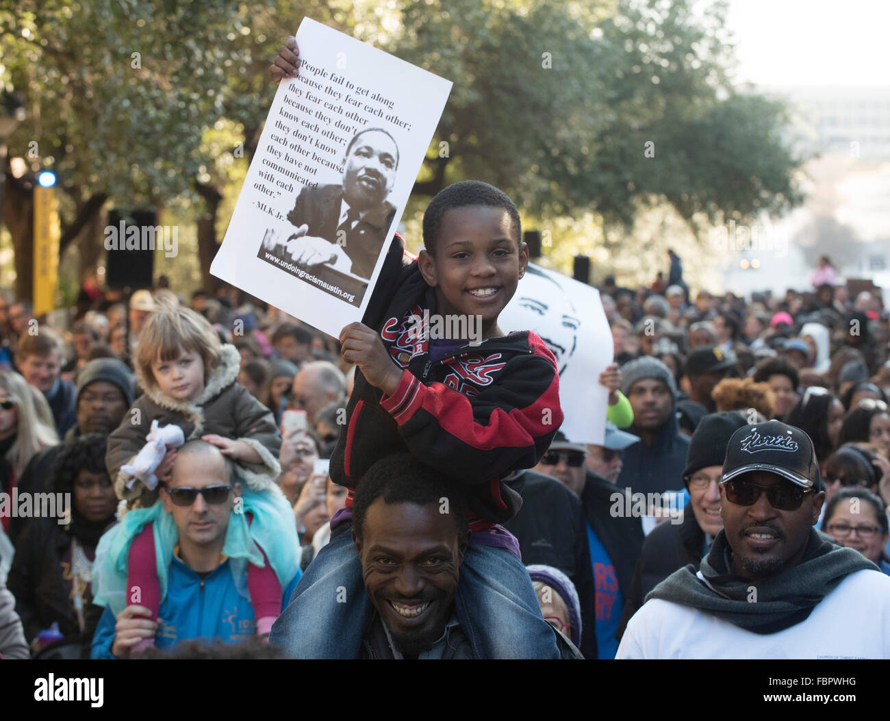 Boy rides on dad's shoulders during march in downtown Austin to honor ...