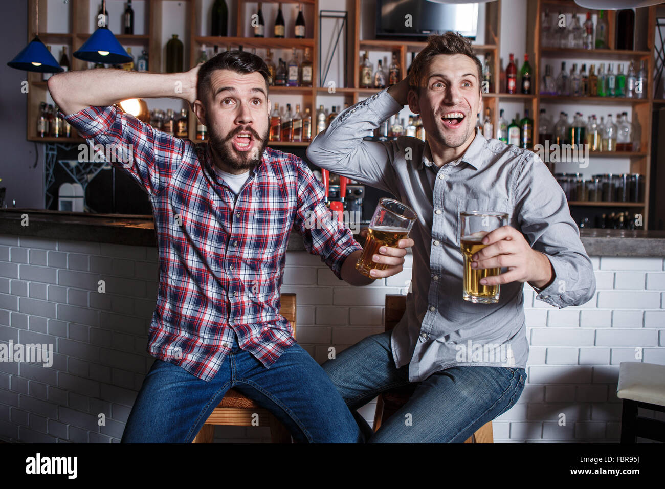 Men cheering in pub hi-res stock photography and images - Alamy
