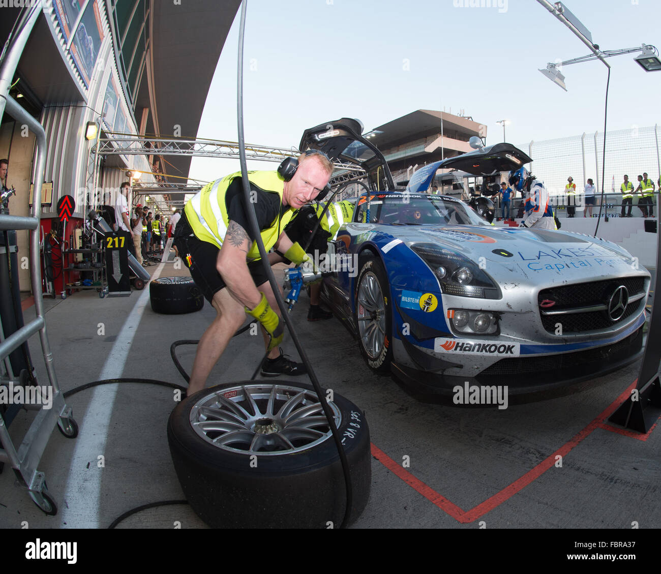 A mechanic changes the wheel of a Mercedes SLS AMG GT3 in the pit lane ...