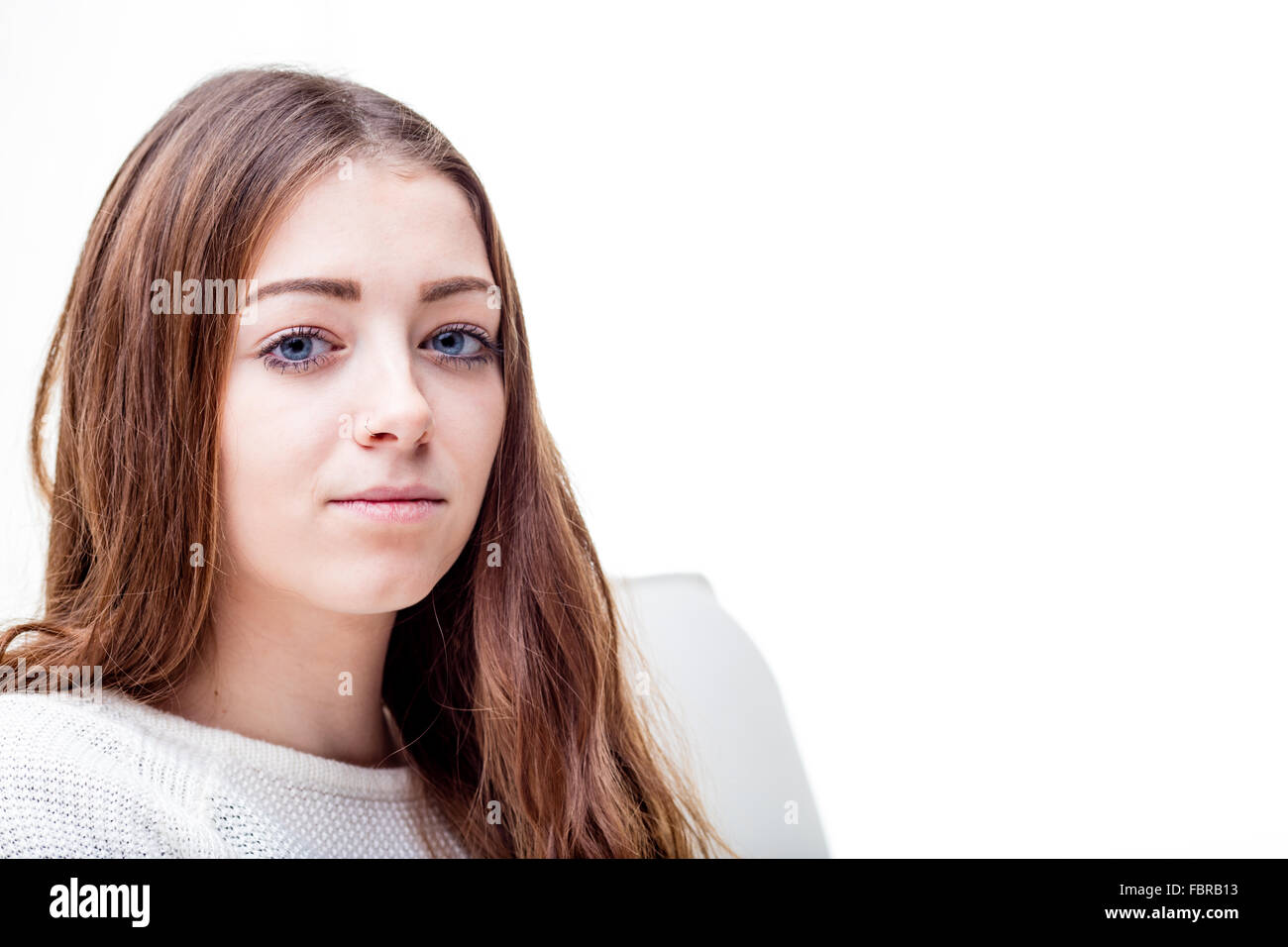 Girl With Blue Eyes And Long Hair Watching In Camera While Sitting