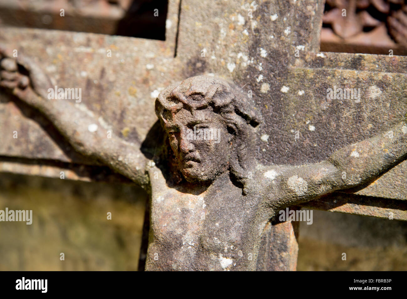 A stone statue of Jesus Christ on a stone cross Stock Photo - Alamy