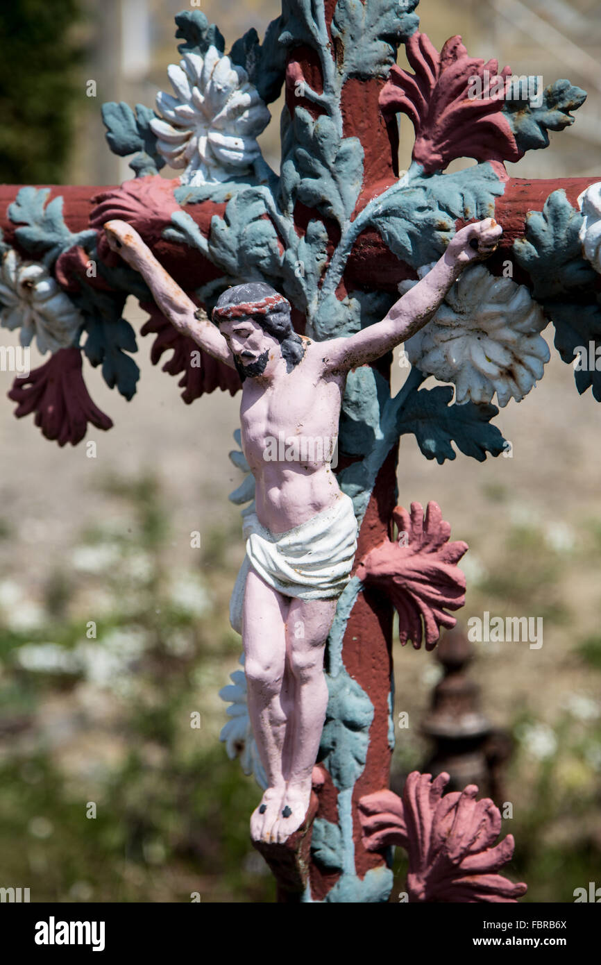A colourful/colorful painted ornate metal iron work effigy of Jesus ...