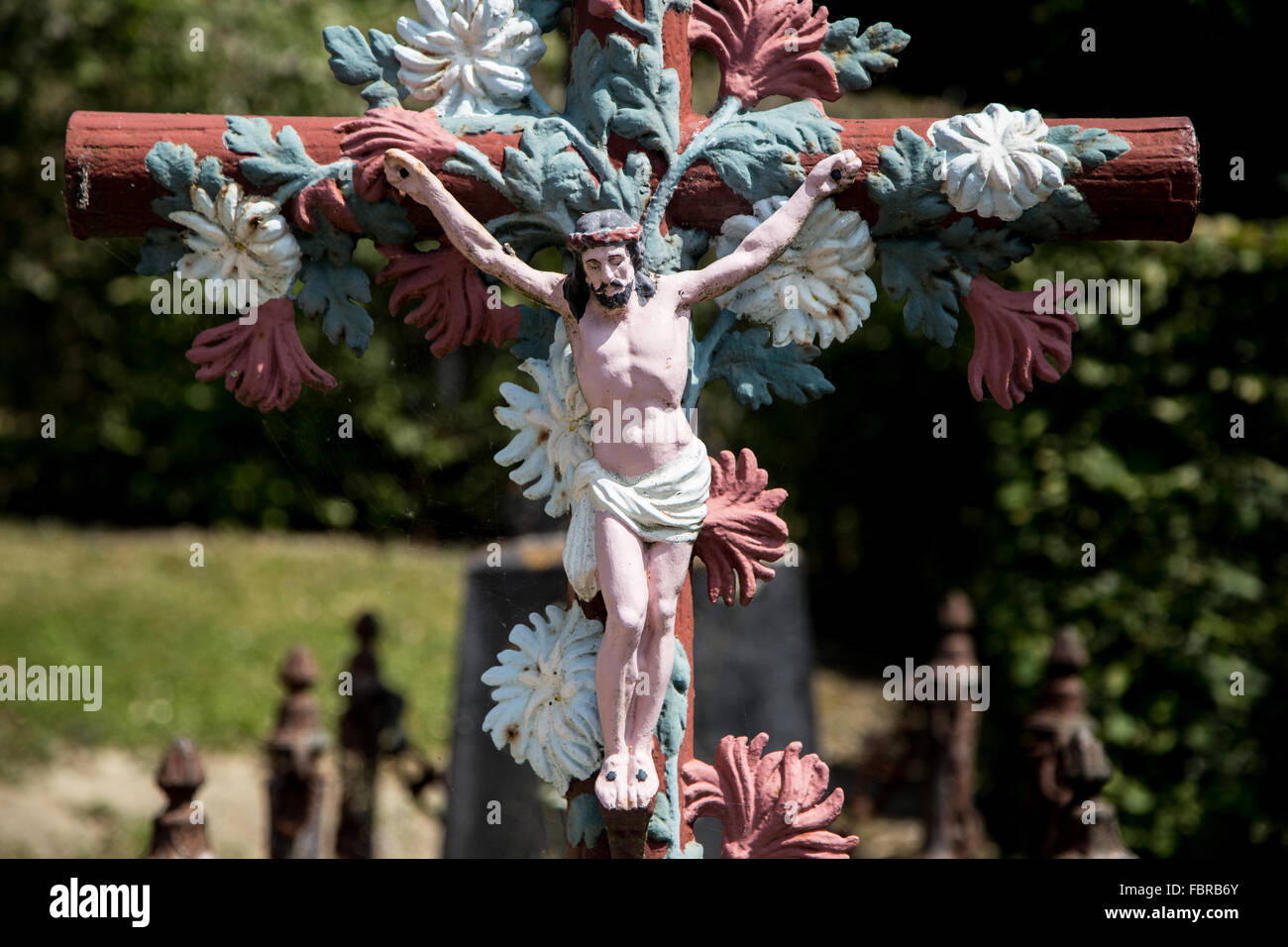 A colourful/colorful painted ornate metal iron work effigy of Jesus ...