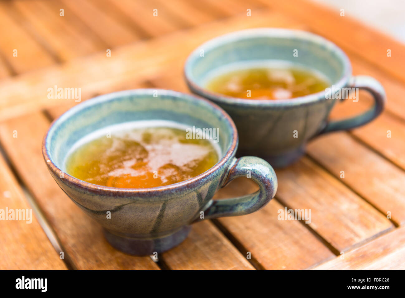 Norman apple cider in a typical ceramic cups. Shot with a selective ...