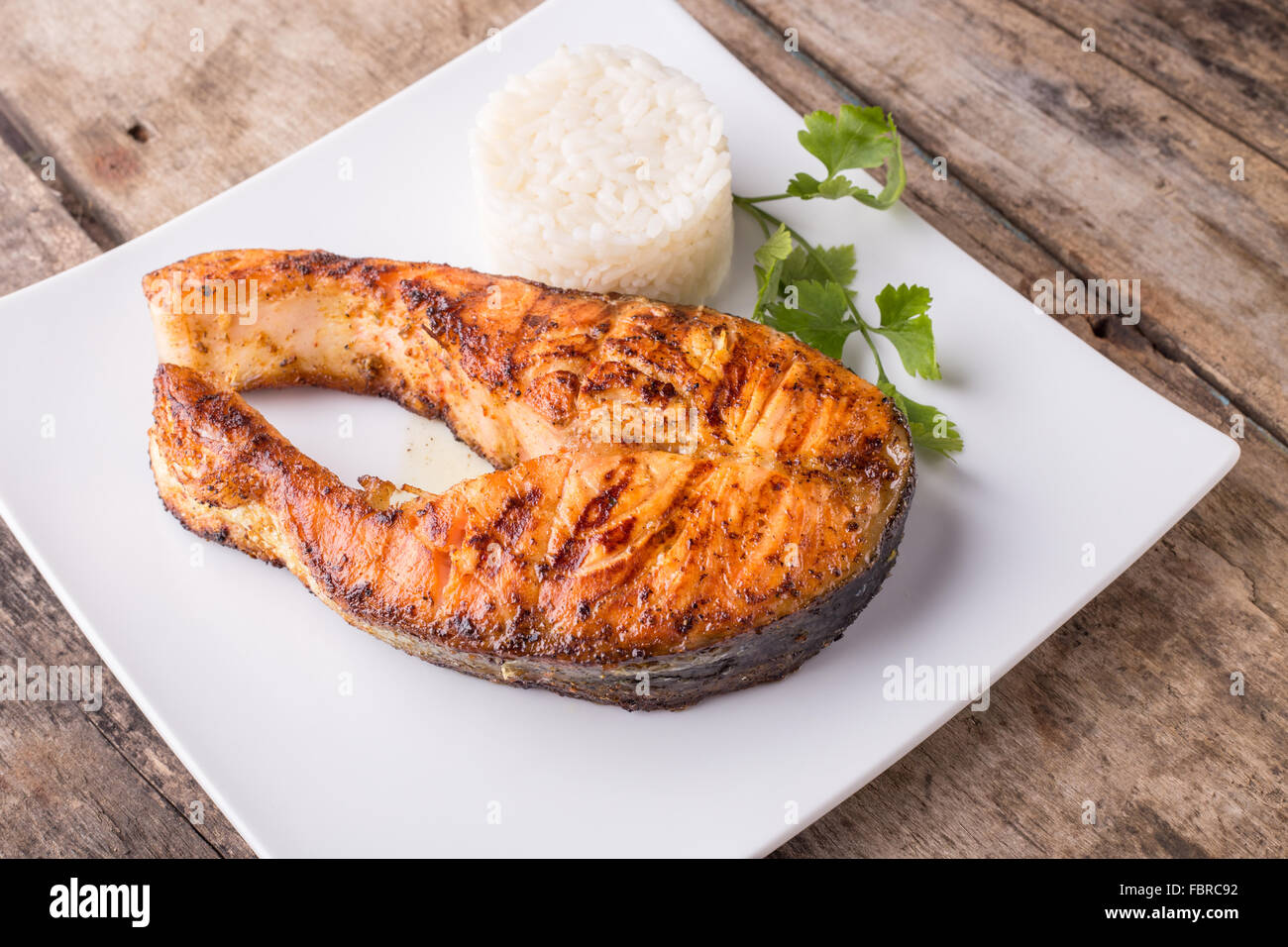 Roasted grill salmon steak with rice on white plate. Restaurant fish ...