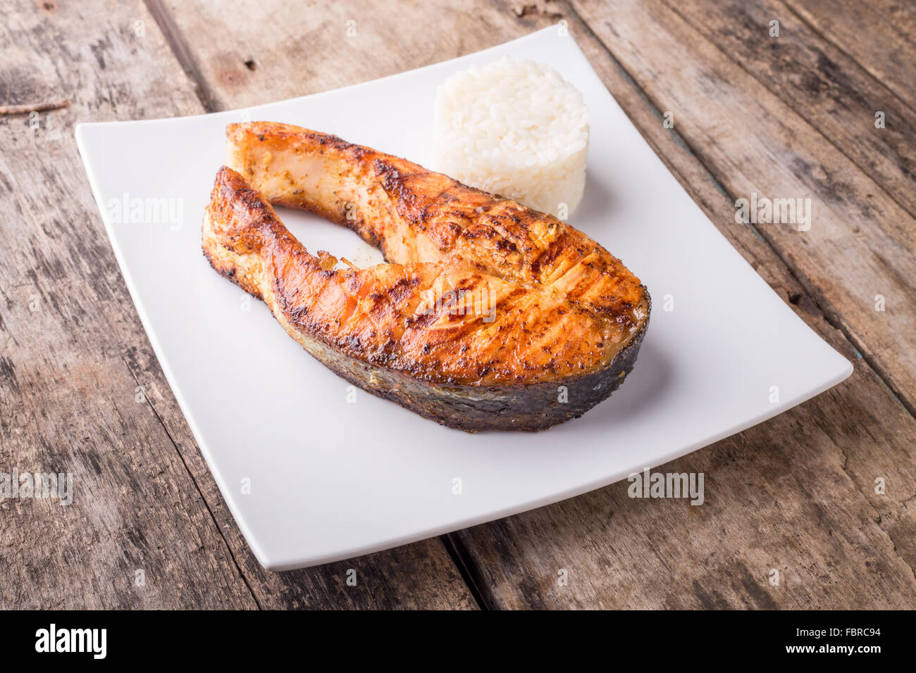 Roasted grill salmon steak with rice on white plate. Restaurant fish ...