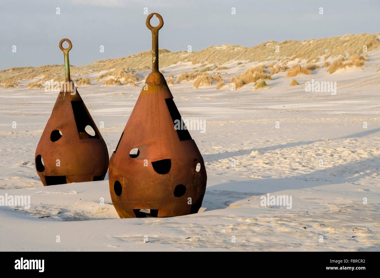 Old rusted shackles on the beach at Terschelling in the Netherlands ...