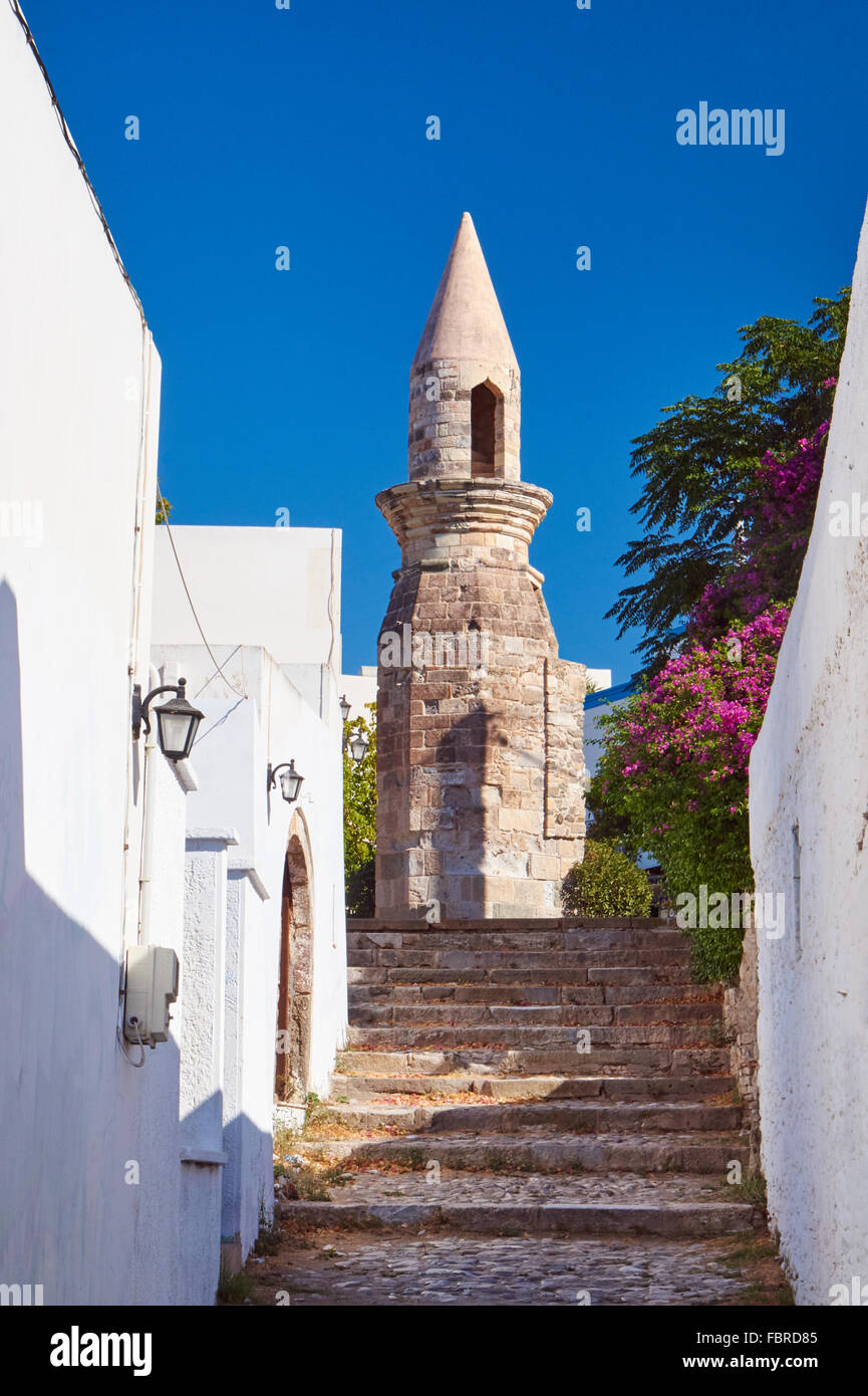 Cobbled street and the Turkish minaret in Kos in Greece Stock Photo - Alamy