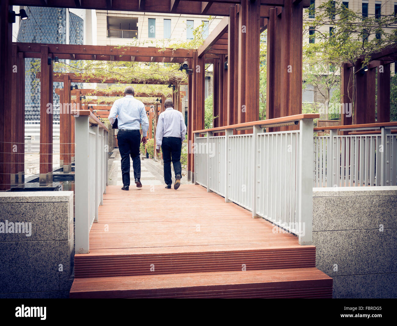 Immigrant workers relaxing, walking during lunch hour in Dubai ...