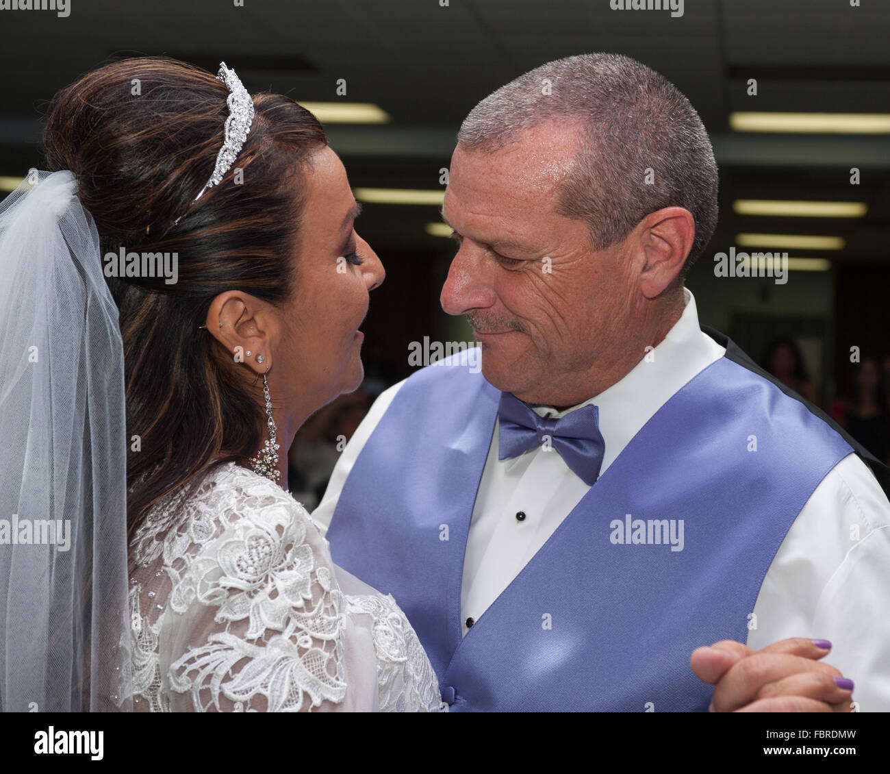 Bride and groom holding each other close Stock Photo - Alamy