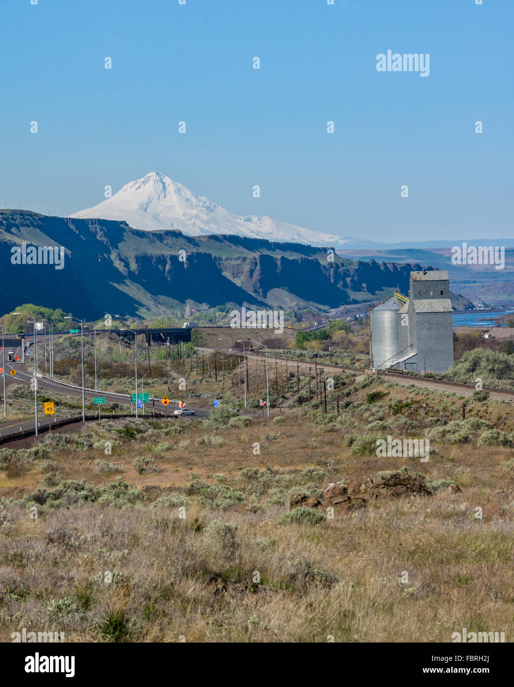 View of Mount Hood and grain elevator along the Columbia River. Rufus ...