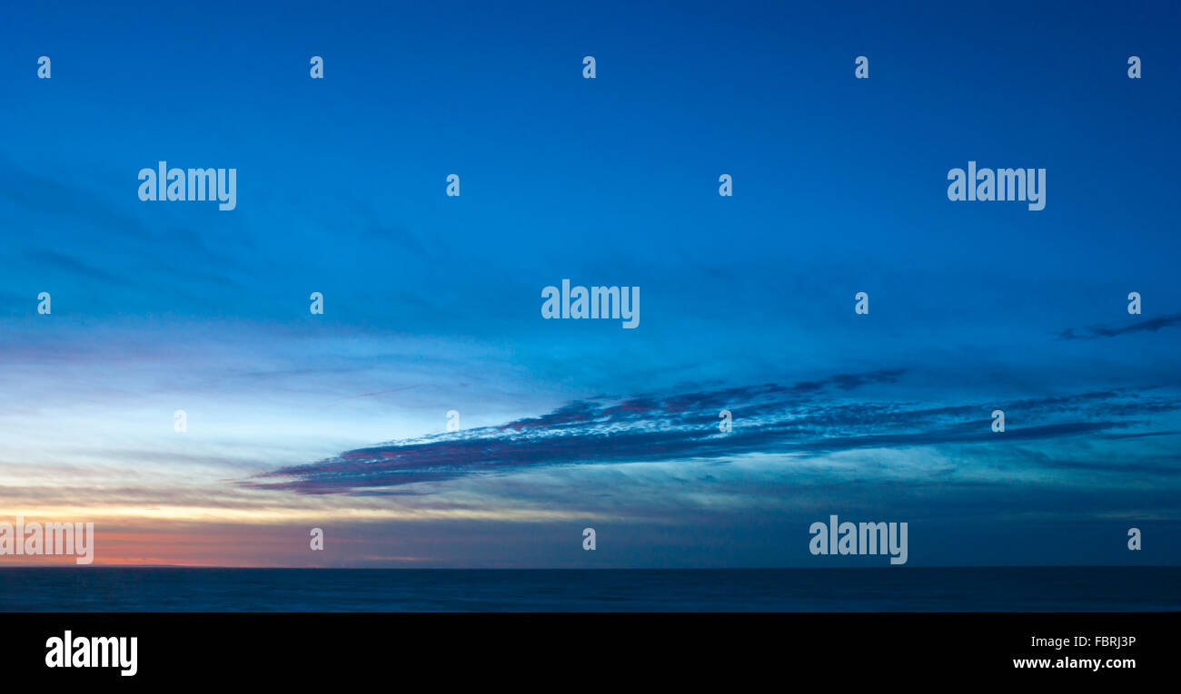 Sunset sky with clouds over the ocean Stock Photo - Alamy
