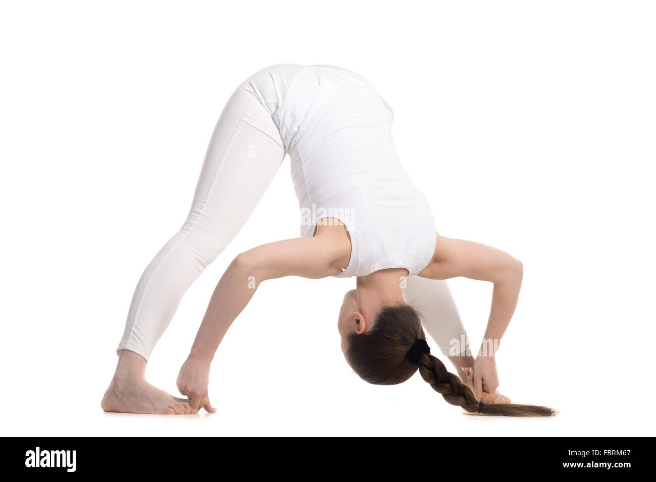 Sporty beautiful young woman in white sportswear doing Standing ...