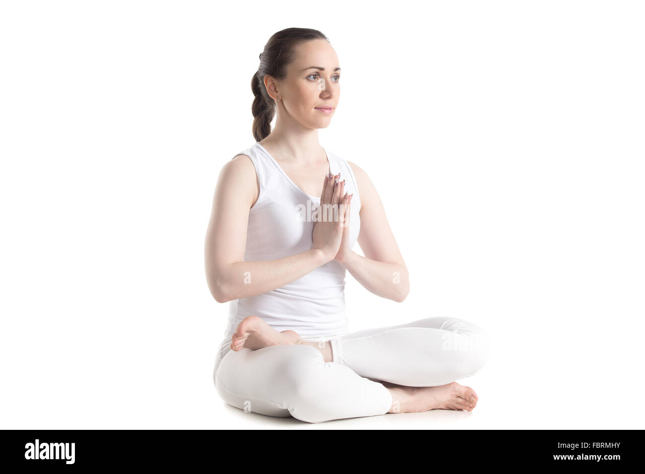 Sporty attractive young woman in white sportswear sitting in Ardha ...
