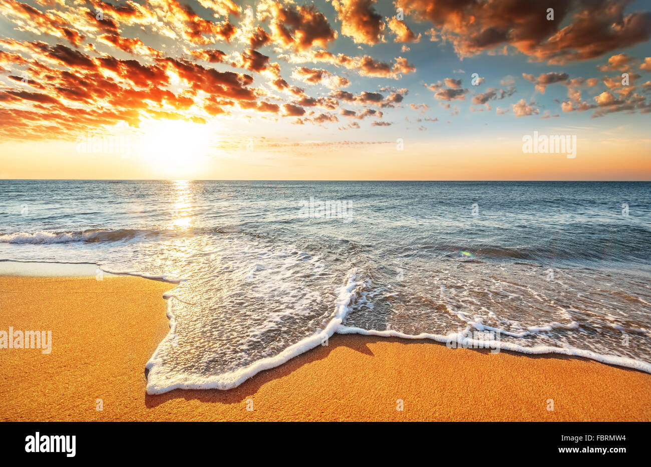 Brilliant ocean beach sunrise Stock Photo - Alamy